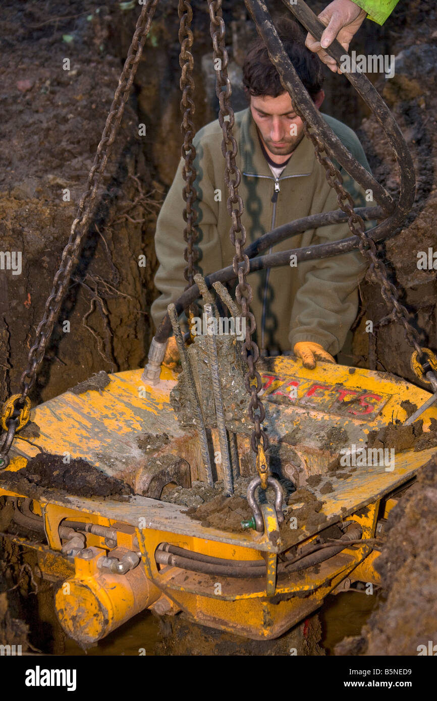 A pile crusher in action breaking the concrete on the top of a concrete ...