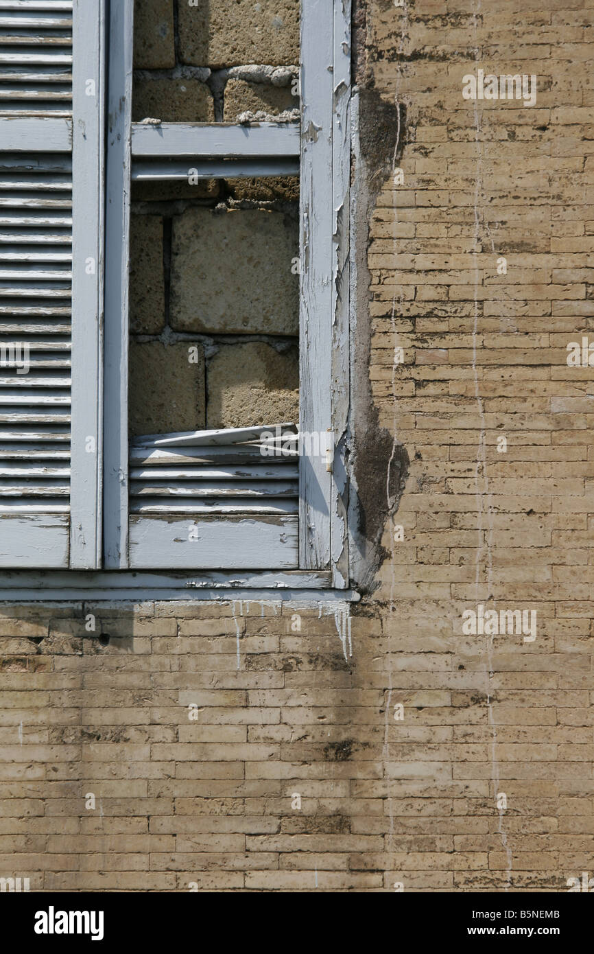one damaged window shutters in derelict property Stock Photo - Alamy