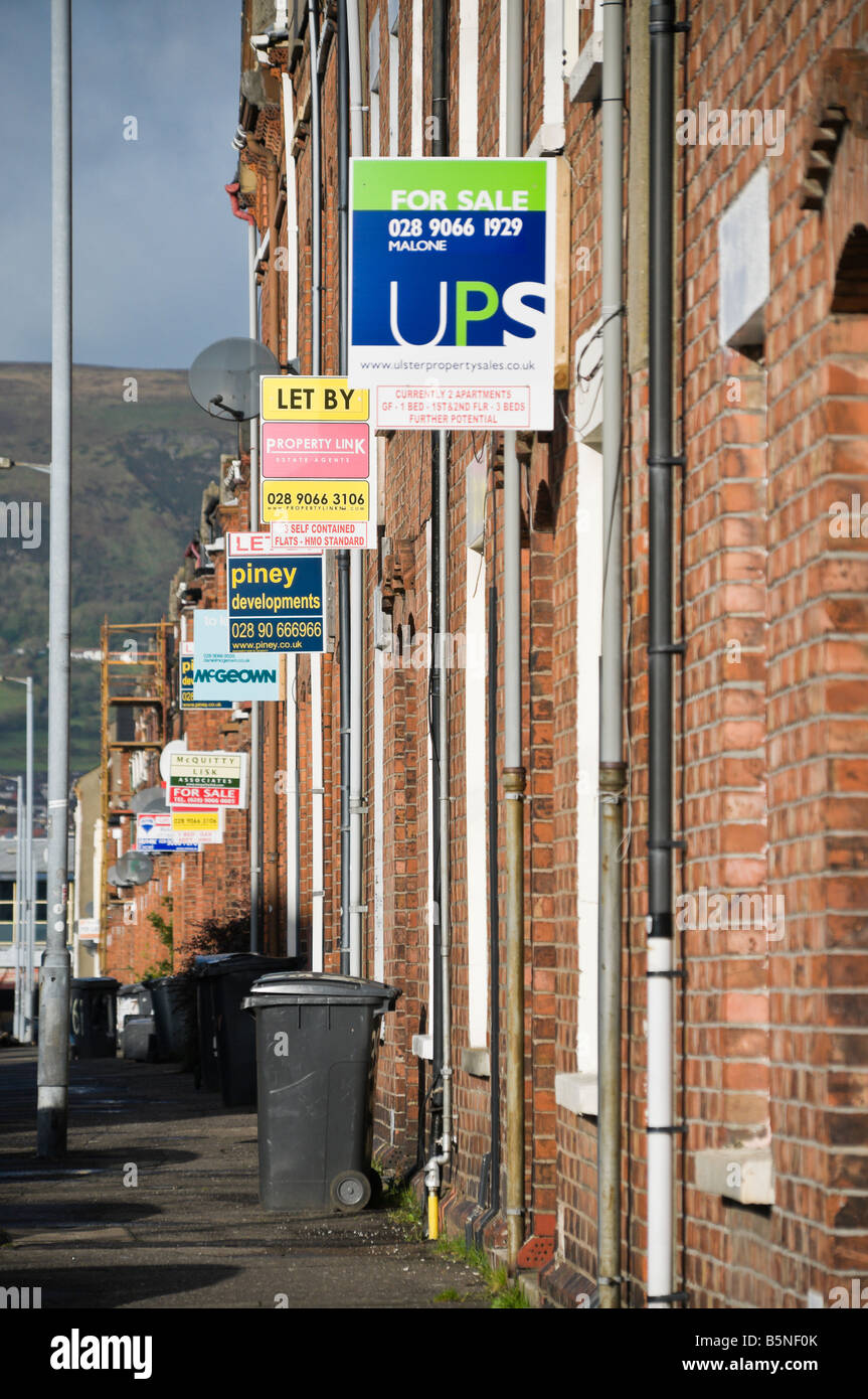 For sale and To Let signs along a street in Belfast Stock Photo - Alamy