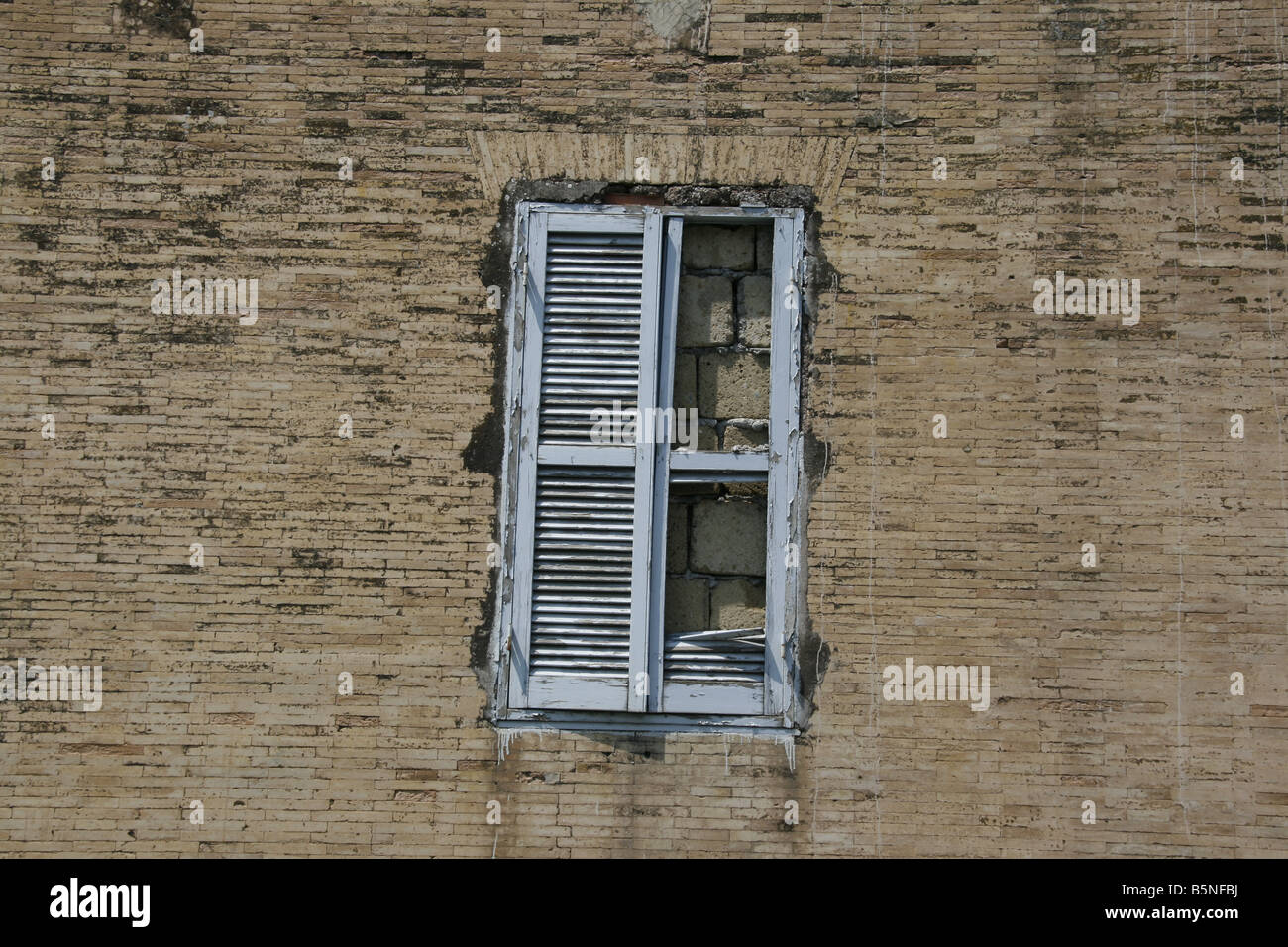 one damaged window shutters in derelict property Stock Photo - Alamy