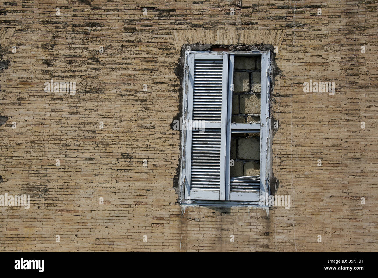one damaged window shutters in derelict property Stock Photo - Alamy