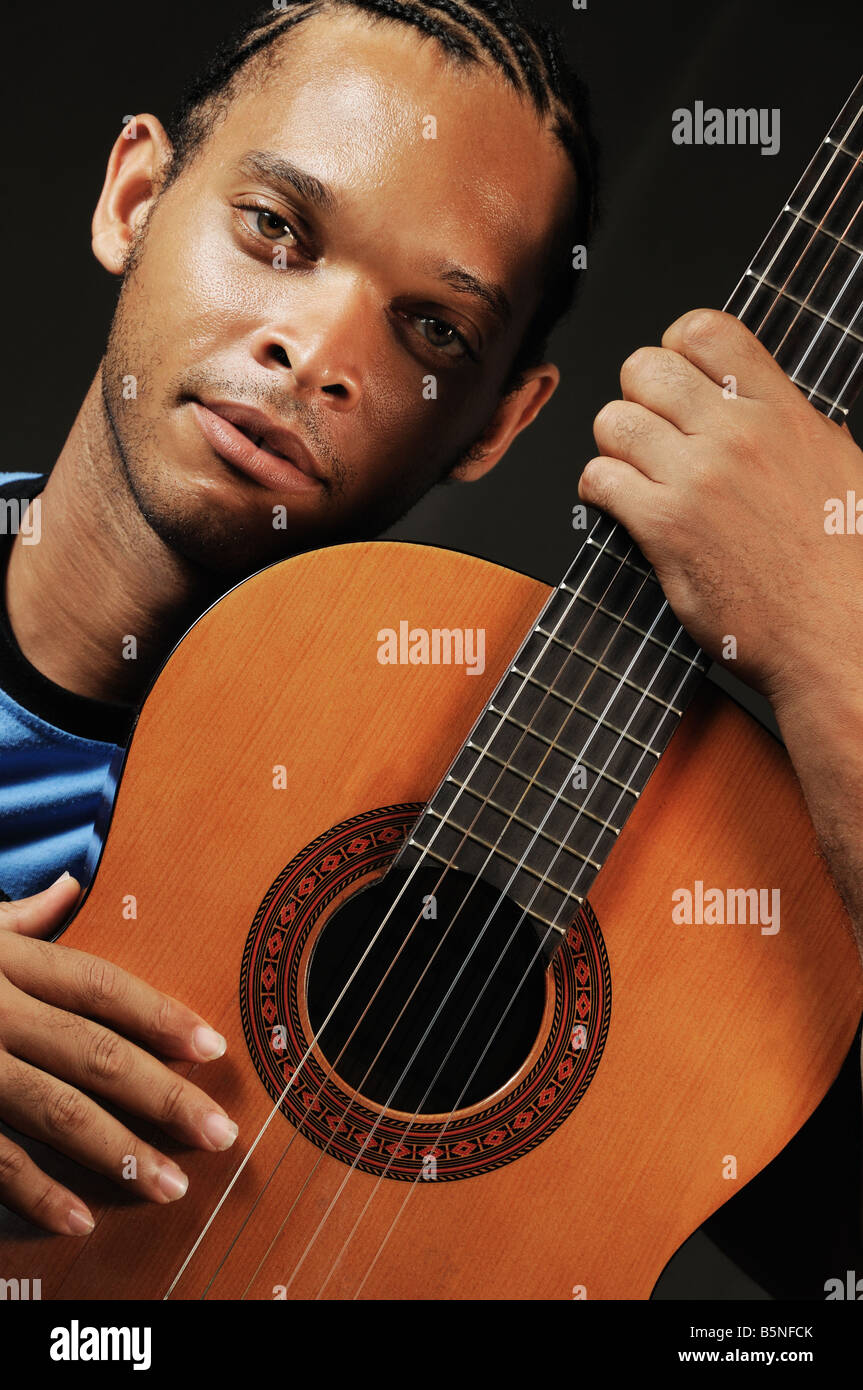 Portrait of young african american man with acoustic guitar Stock Photo ...