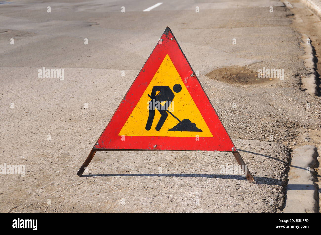 Street with repairing sign warning Stock Photo - Alamy