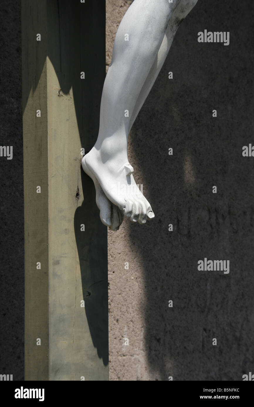 close up of feet of jesus on cross statue by street road in lazio italy ...