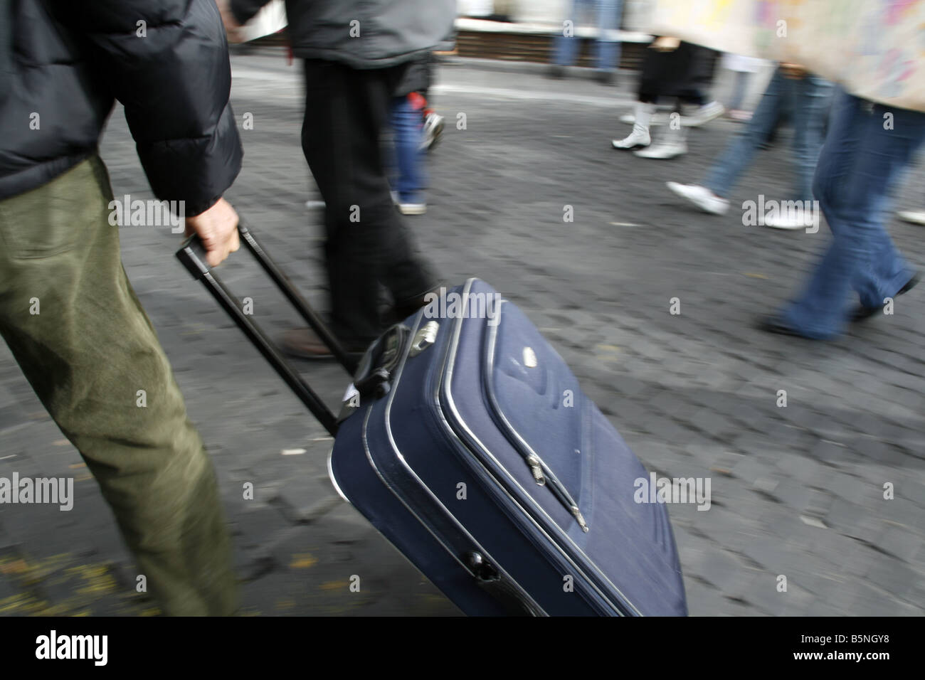 young man pulling trolley luggage case in town Stock Photo - Alamy