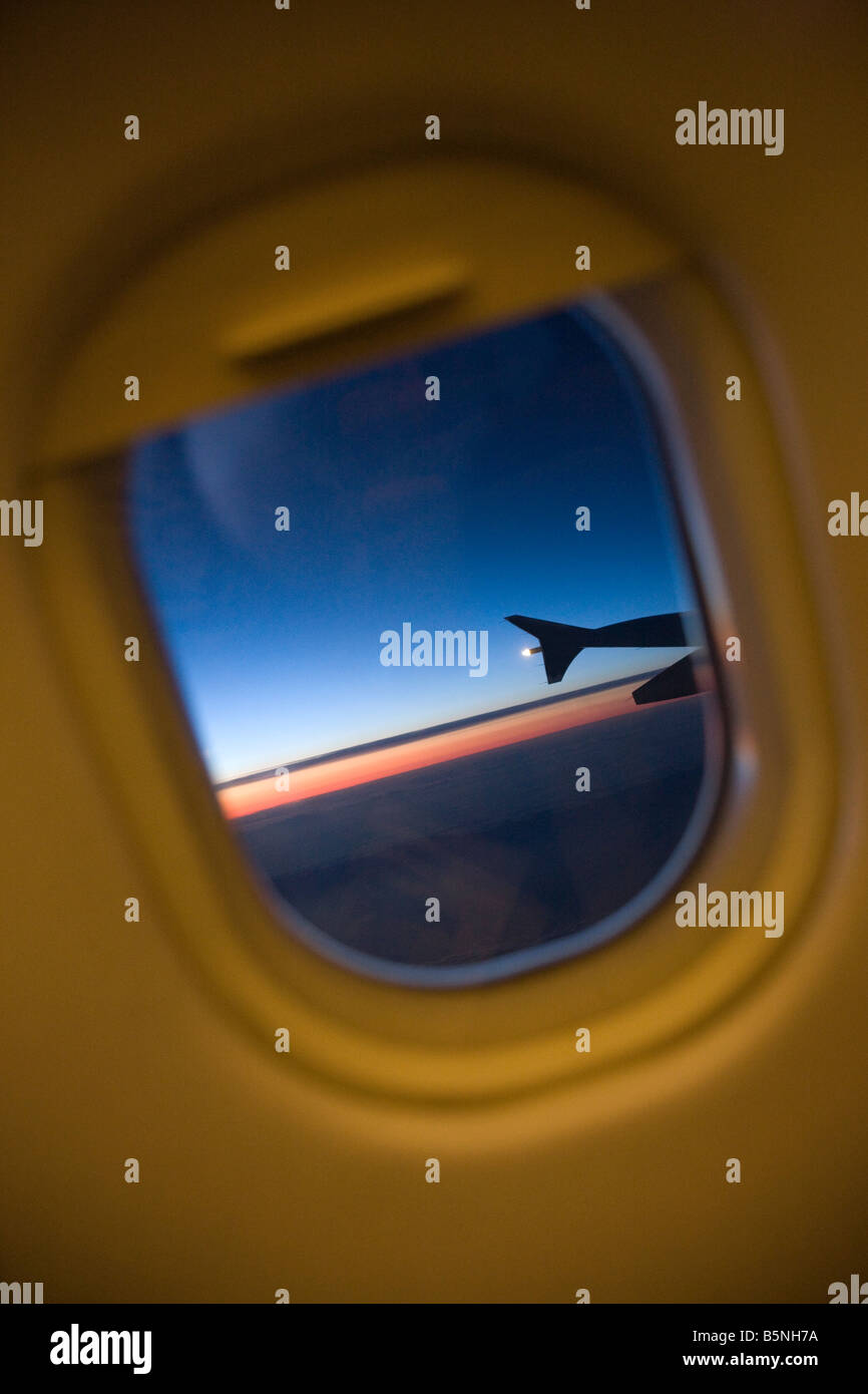 TWILIGHT VIEW THROUGH COMMERCIAL AIRLINER PASSENGER CABIN WINDOW FRAME ...