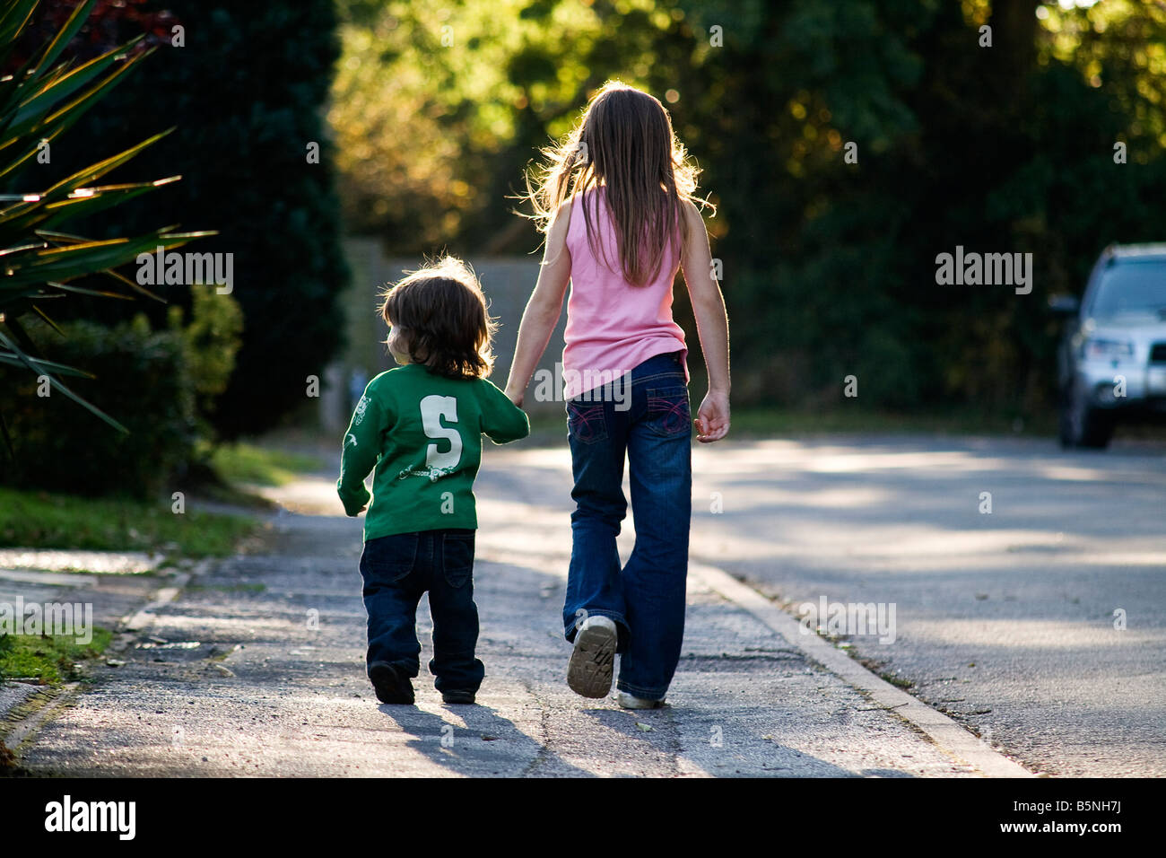 Two lost children walking down a road Stock Photo - Alamy