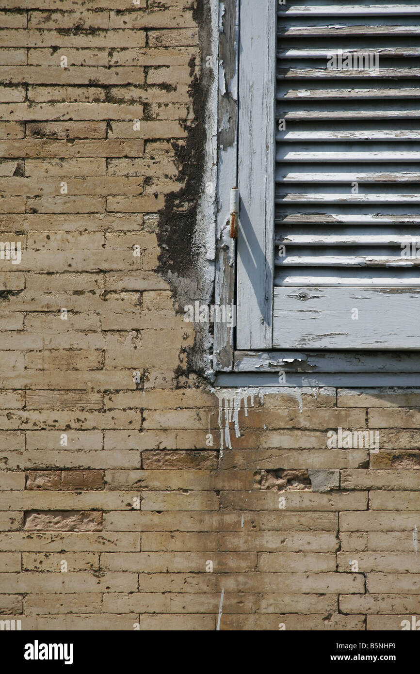 one damaged window shutters in derelict property Stock Photo - Alamy