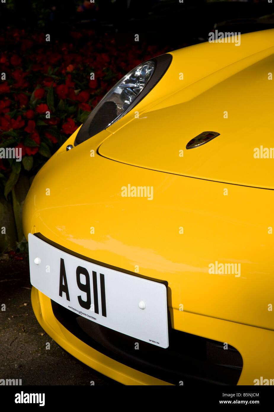 Front end of a yellow Porsche 911 with personalised plate in the ...