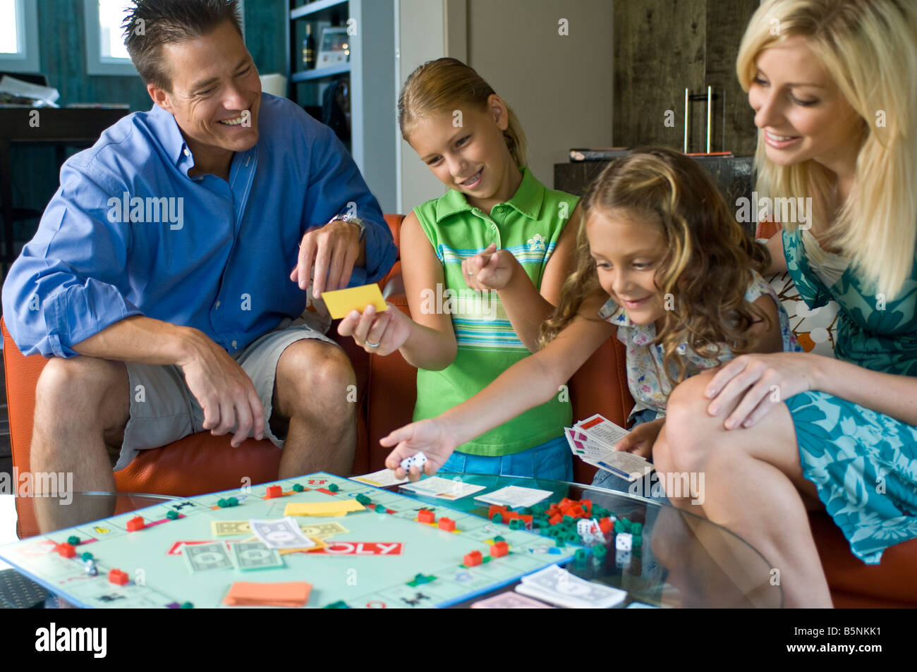 Family at home playing a board game Stock Photo - Alamy