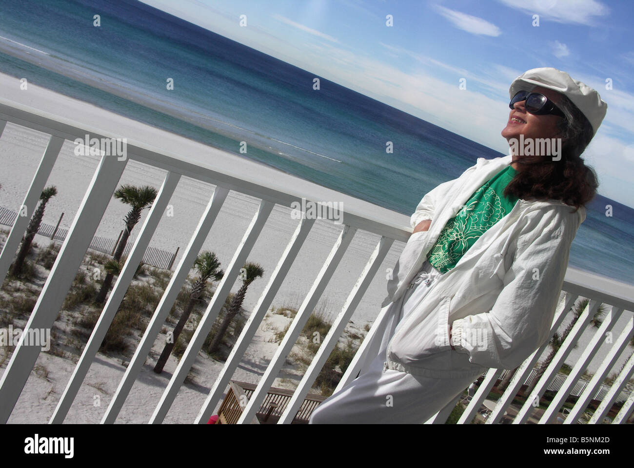 Woman standing balcony railing overlooking hi-res stock photography and ...