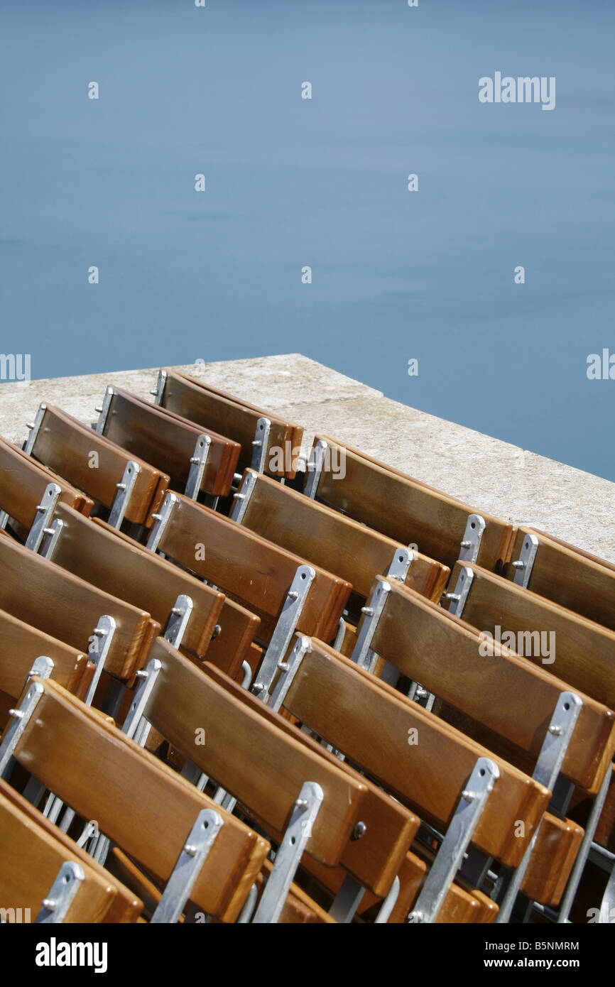 many folded wooden chairs by lake outdoors Stock Photo - Alamy