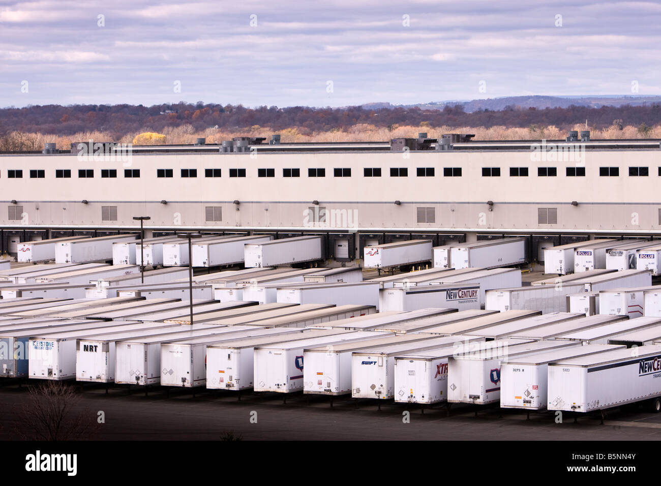Trailers at a warehouse Stock Photo - Alamy