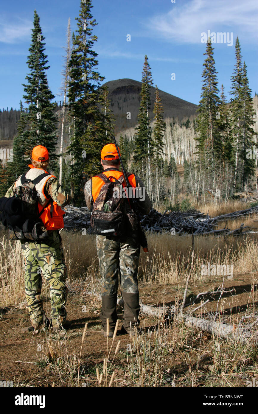 Two hunters standing together and looking at a mountain Stock Photo - Alamy
