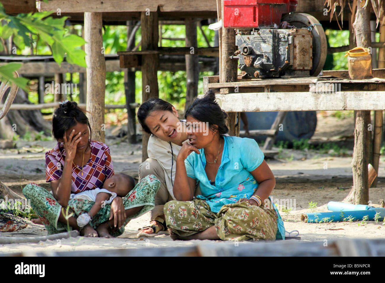 seated moken women (sea gypsy) talking, mu ko surin national park ...