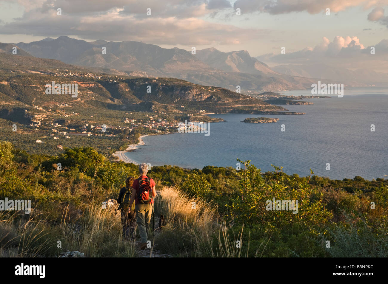 Walkers on a Kalderimi, stone path, above the Outer Mani coast looking ...