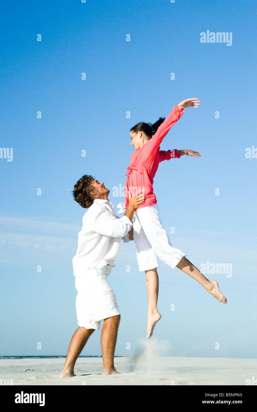 Happy friends dancing on sand hi-res stock photography and images - Alamy