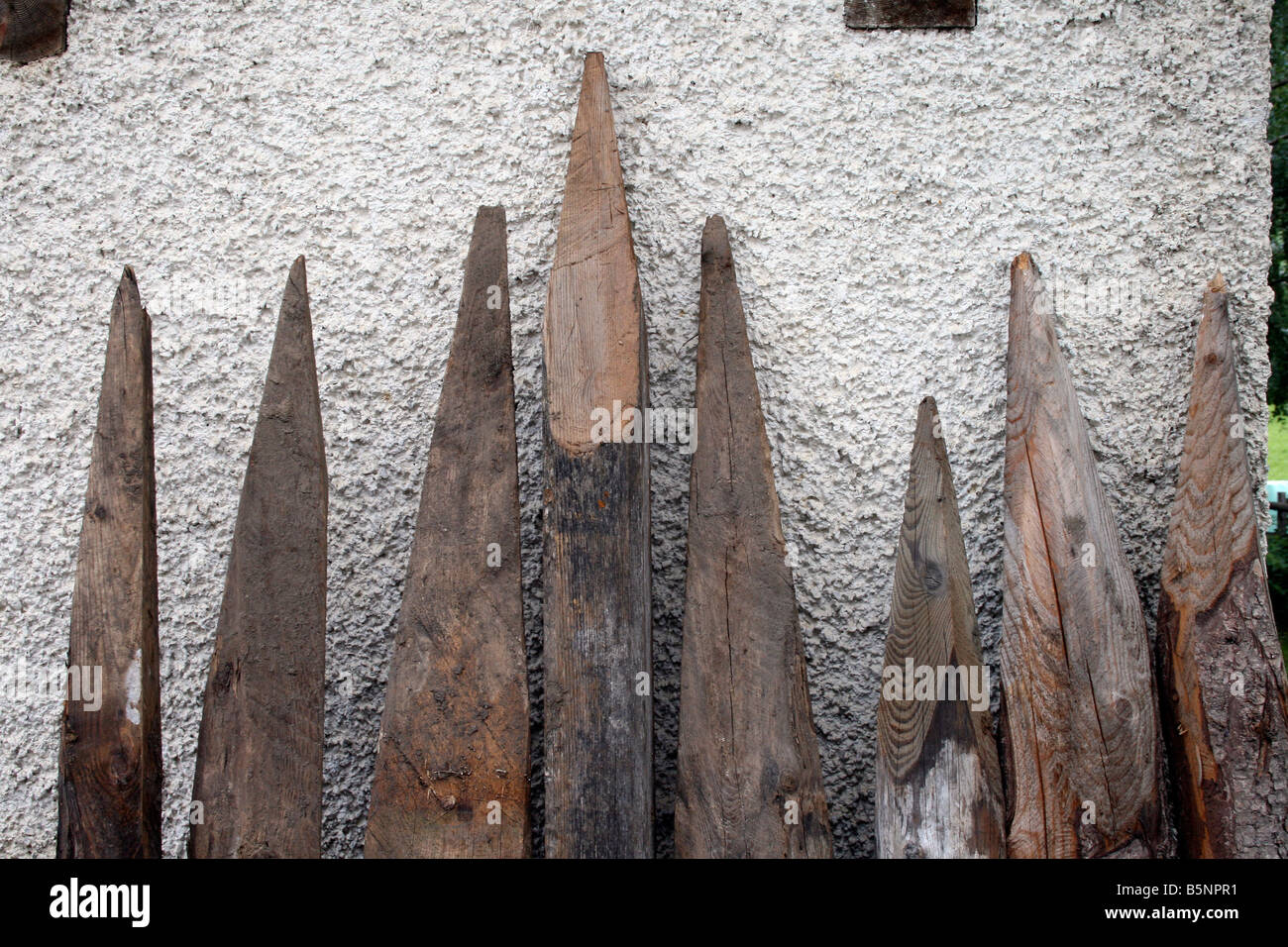 Wooden posts against white wall Stock Photo - Alamy