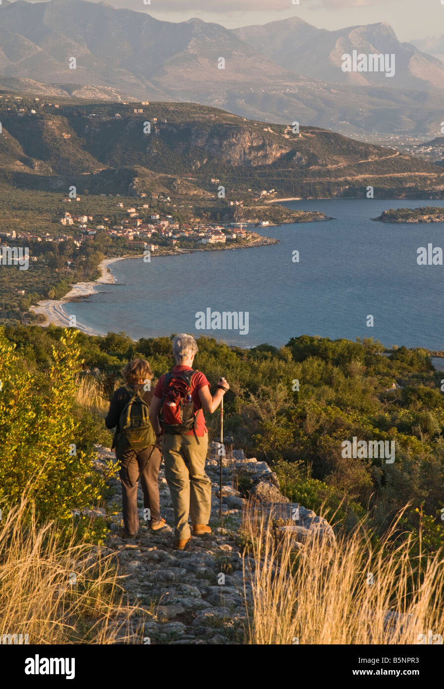 Walkers on a Kalderimi, stone path, above the Outer Mani coast looking ...