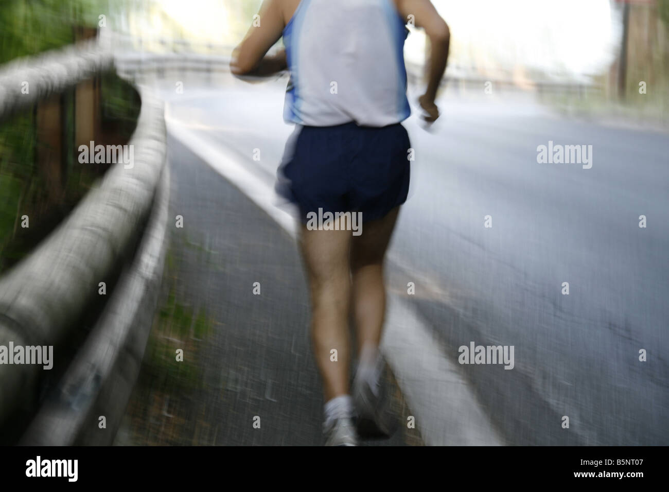 one fast runner in action on street in countryside Stock Photo - Alamy