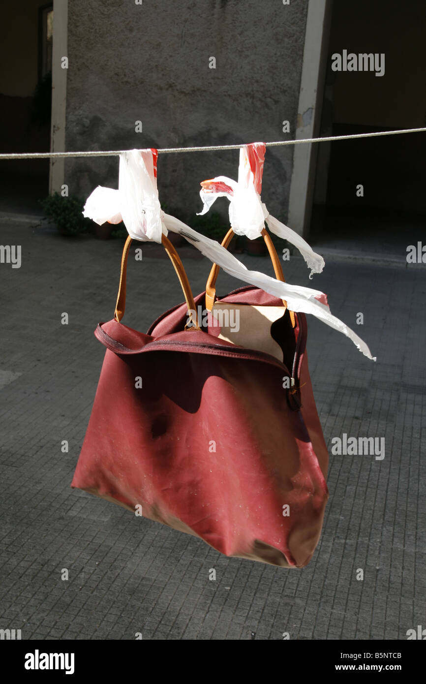 old woman's bag used as a peg container holder on clothes line in italy ...