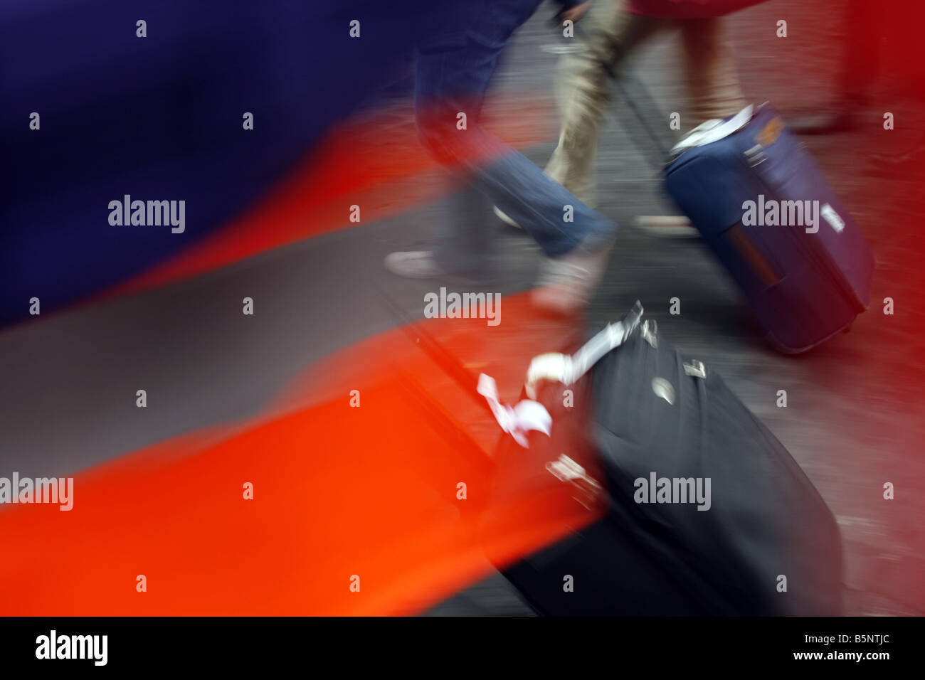 young people pulling trolley luggage cases in town Stock Photo - Alamy
