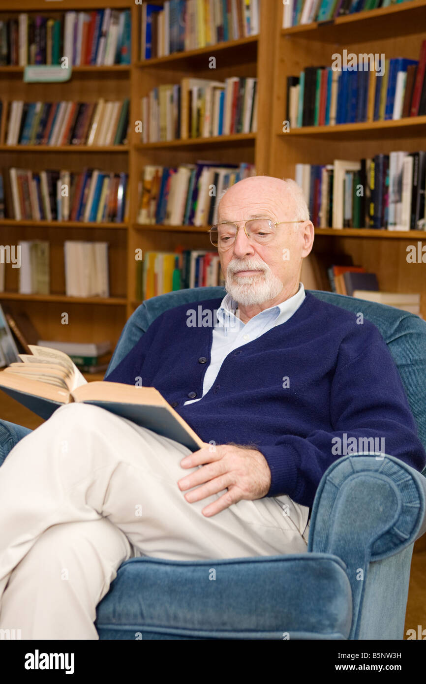 Intelligent senior man reading in the library Stock Photo - Alamy