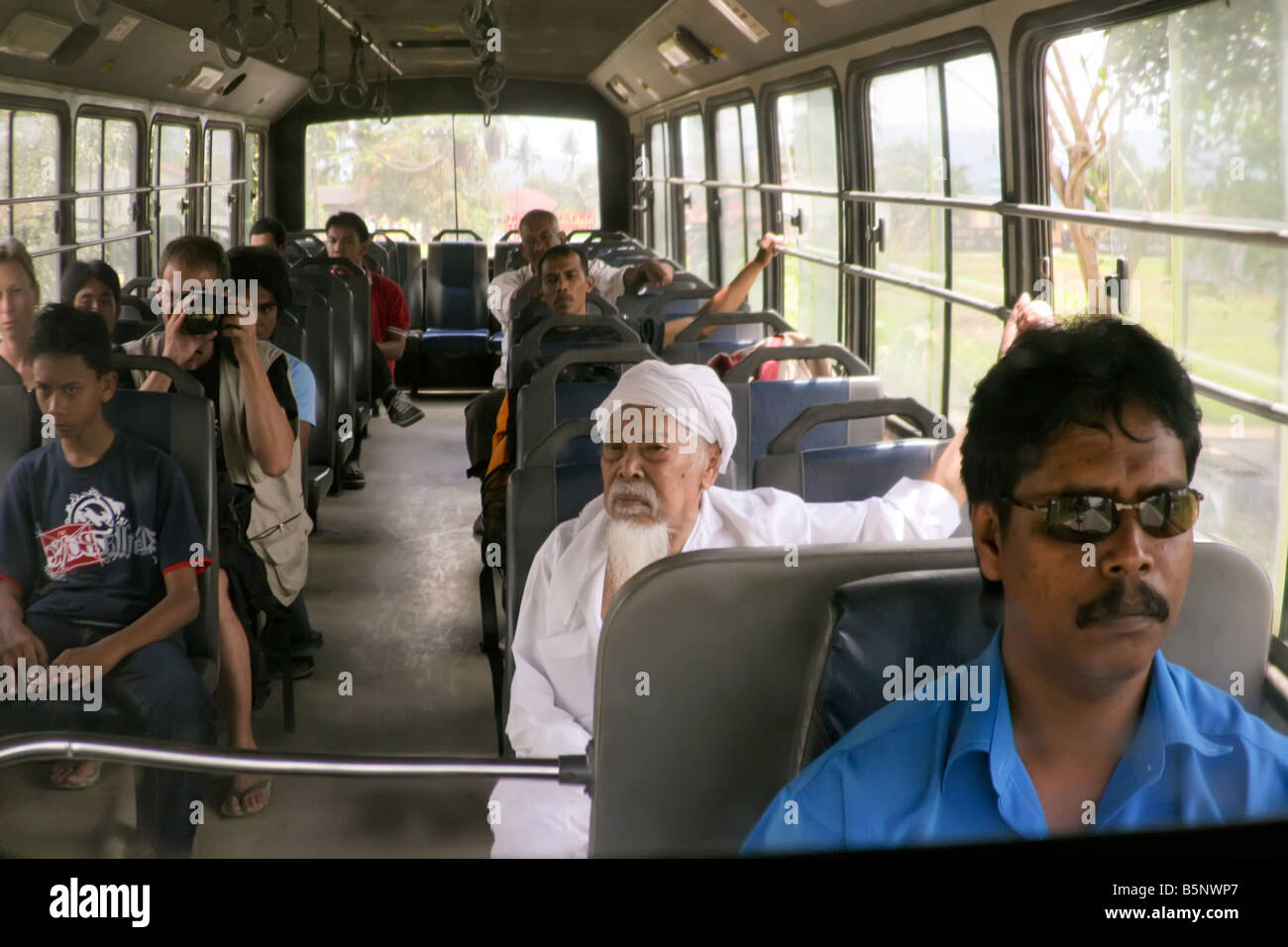 Inside a malaysian bus, view from the rearview's driver mirror ...