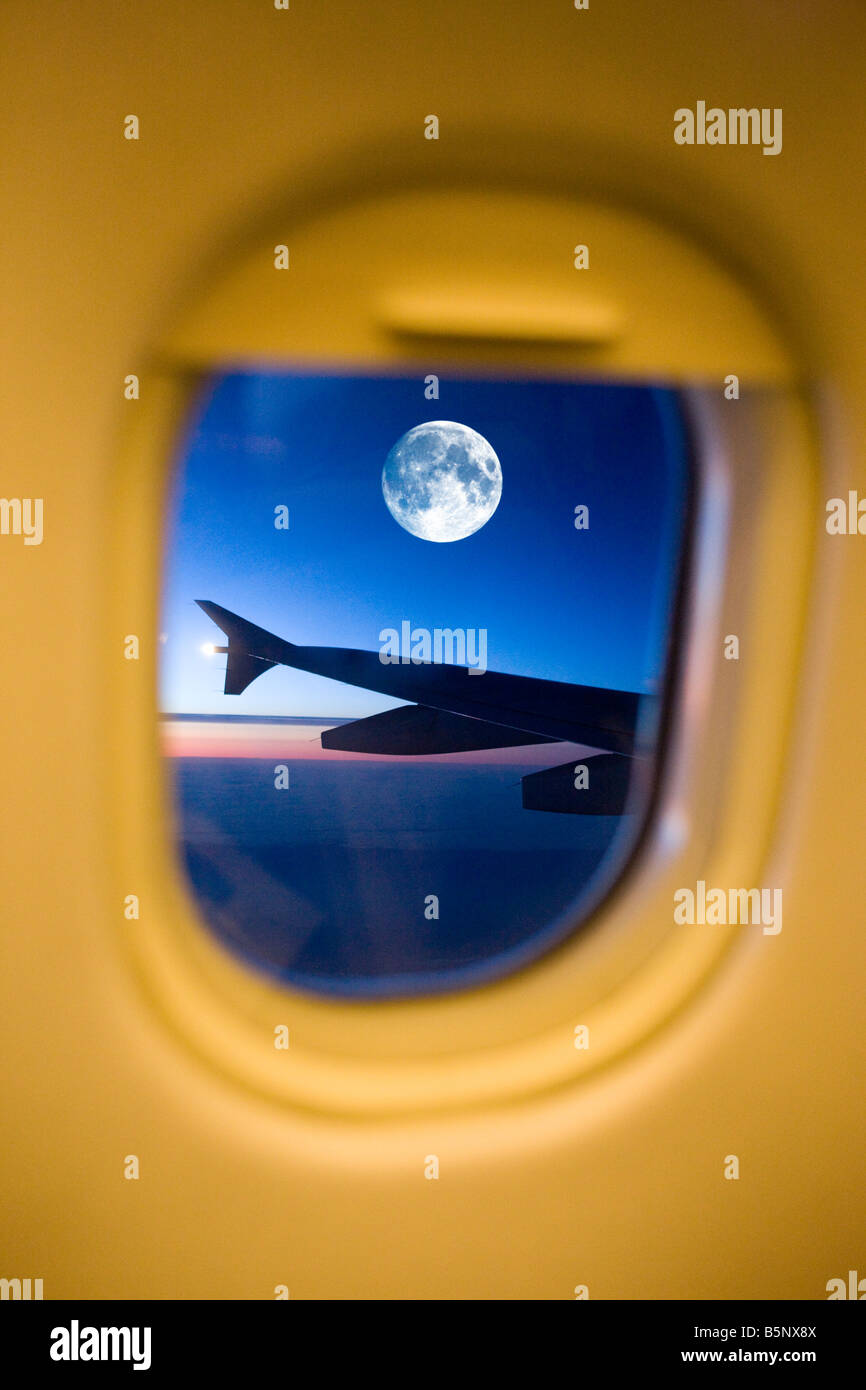 TWILIGHT VIEW THROUGH COMMERCIAL AIRLINER PASSENGER CABIN WINDOW FRAME ...