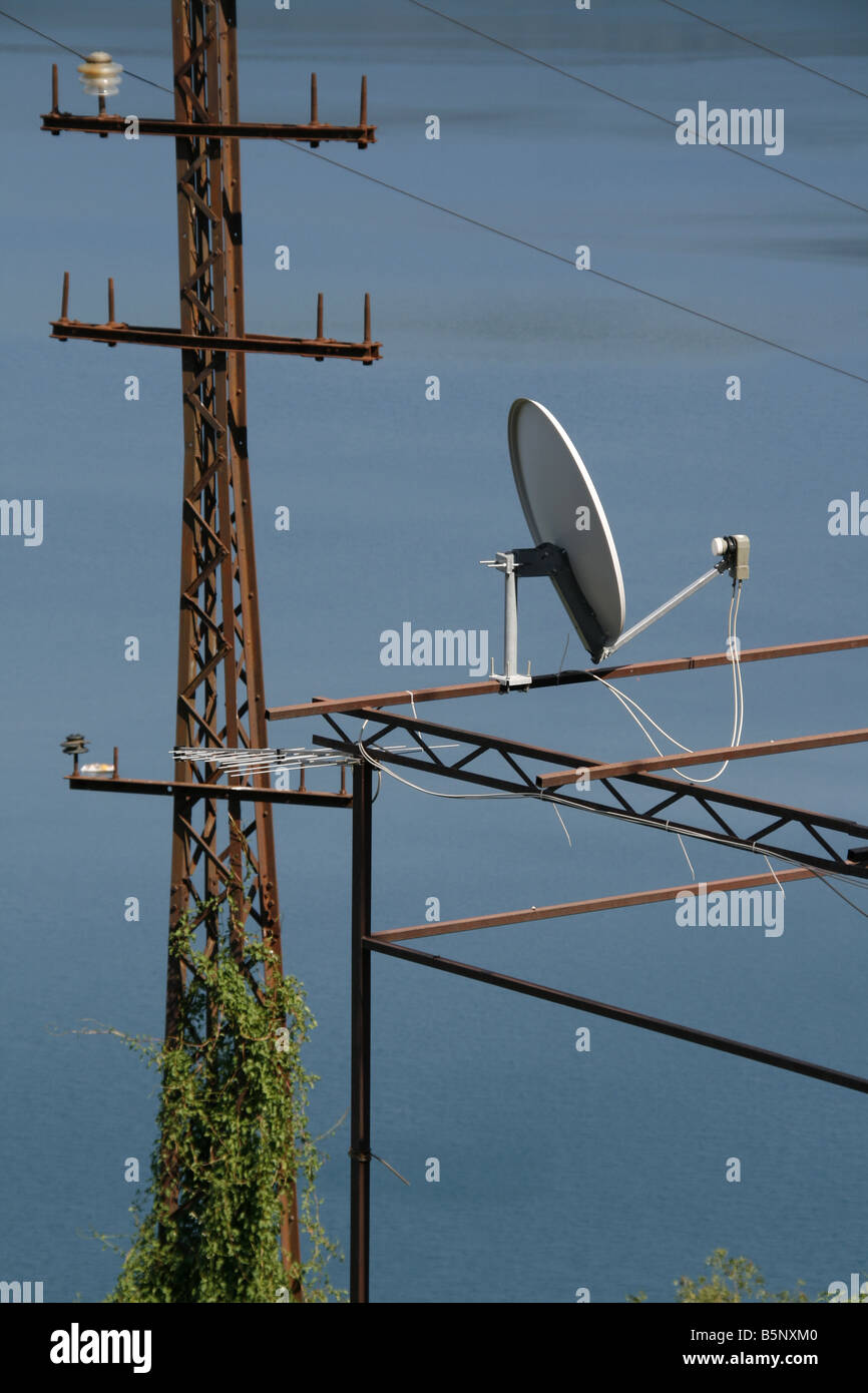 satellite dish receiver and aerials and cables and blue lake sea Stock ...