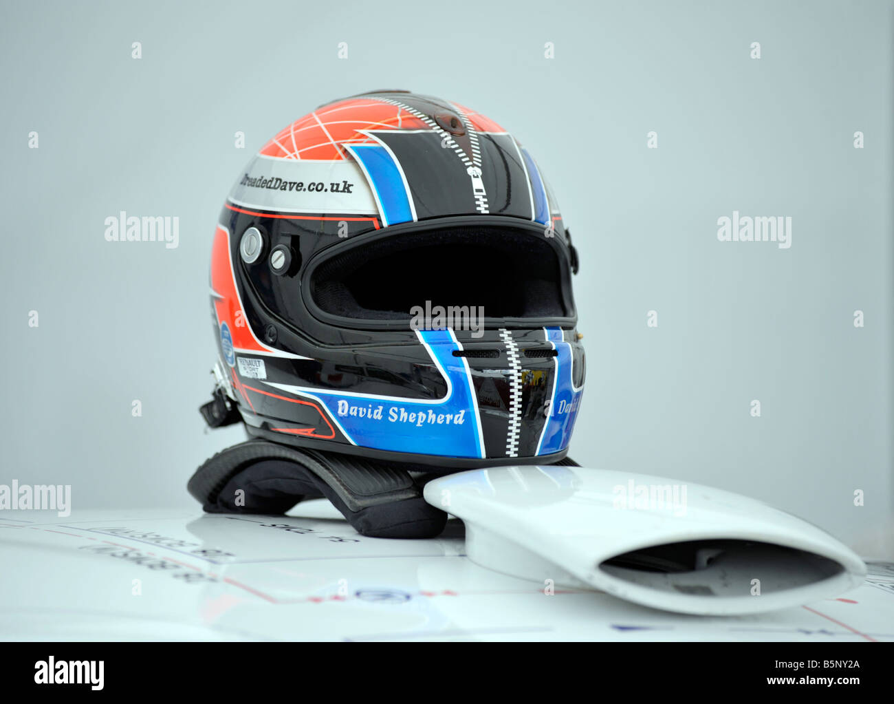 saloon car racing driver's helmet on top of car roof near air vent ...