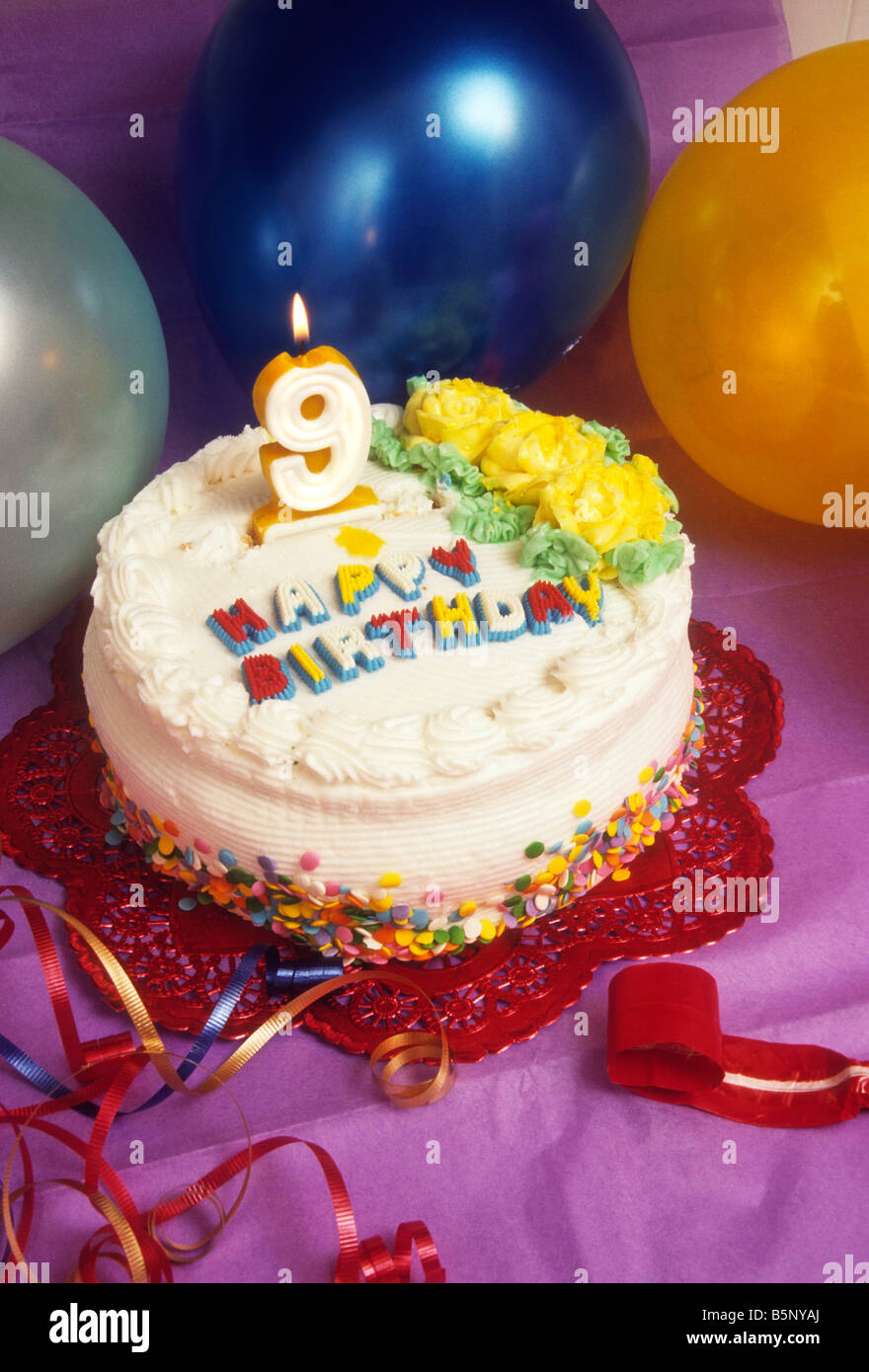 Birthday cake with year 9 candle burning Stock Photo - Alamy