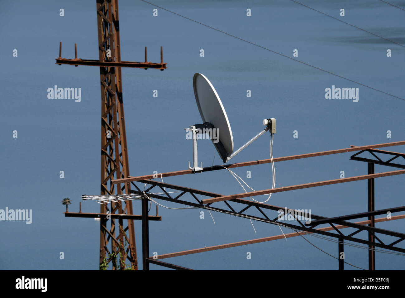 satellite dish receiver and aerials and cables and blue lake sea Stock ...