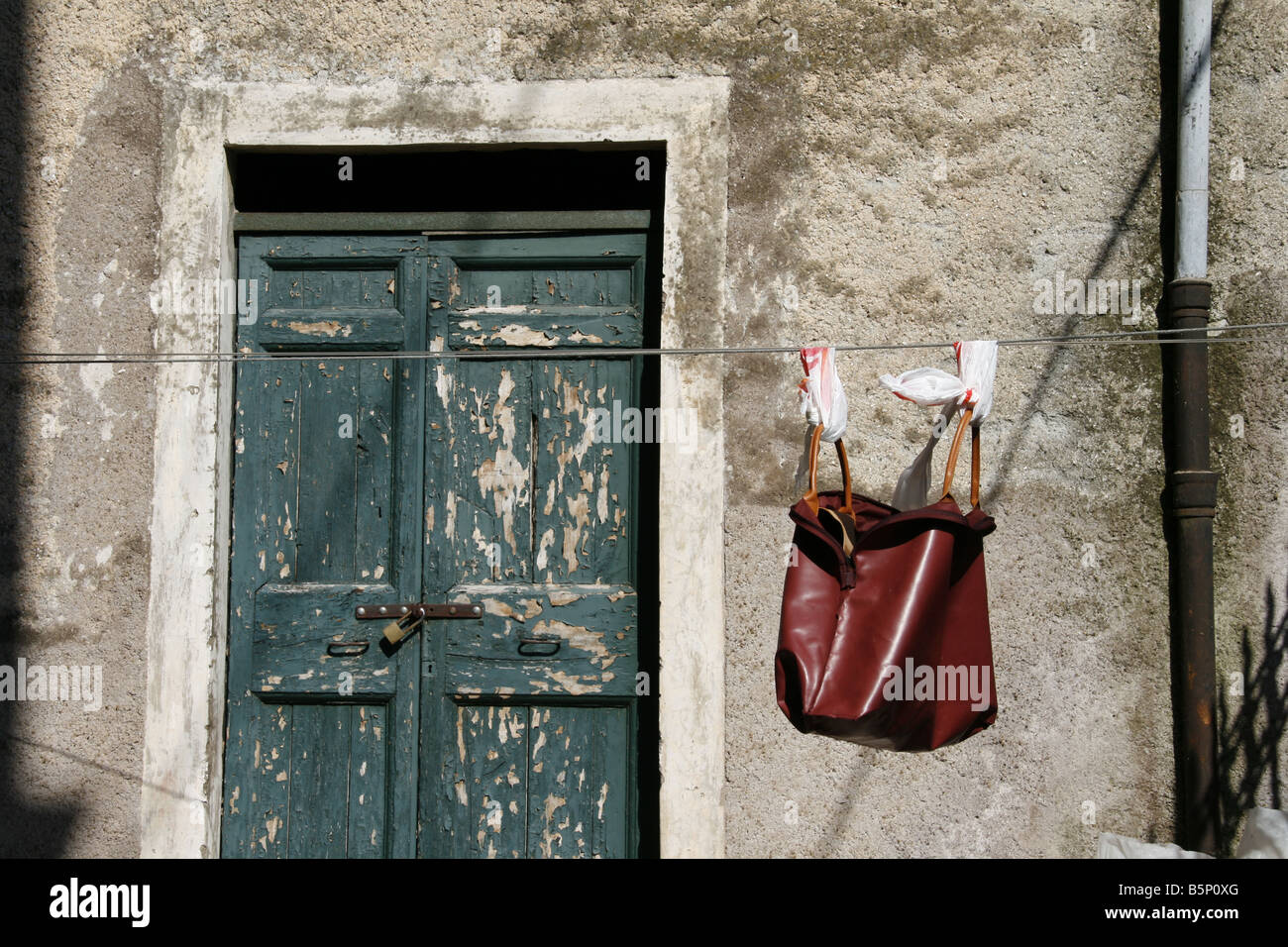 old woman's bag used as a peg container holder on clothes line in italy ...
