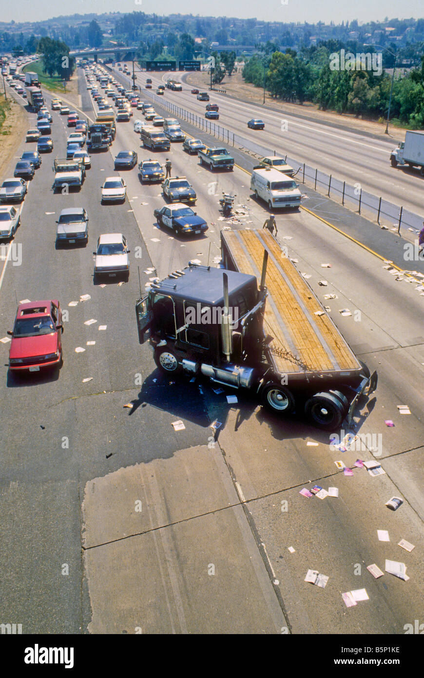 Freeway traffic accident with jackknifed flatbed truck Stock Photo - Alamy