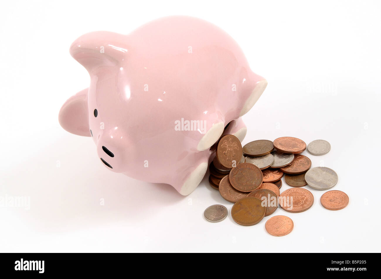 Piggy bank with money coming out Stock Photo - Alamy