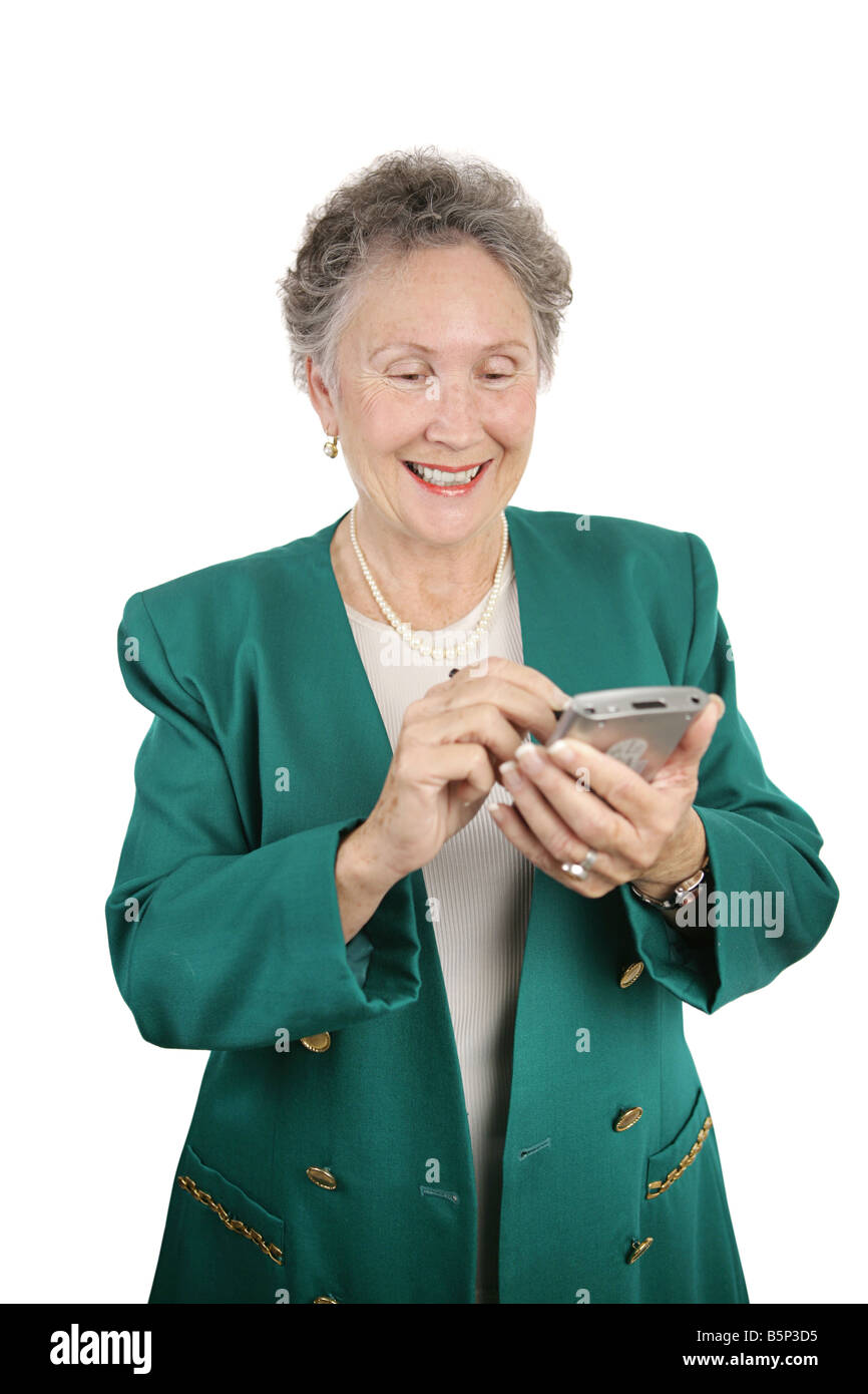 A pretty senior business woman checking her pda Isolated on white Stock ...