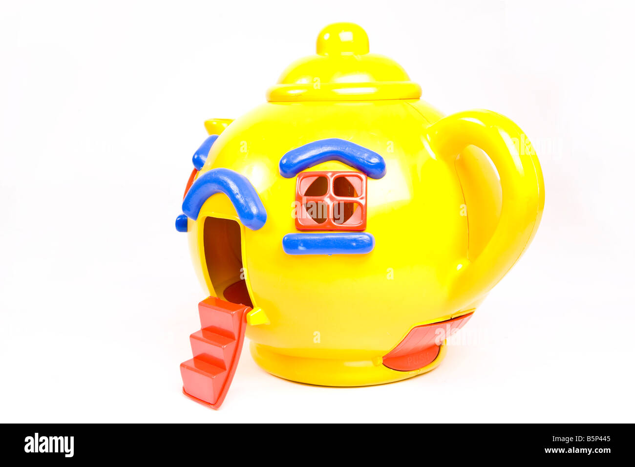 Yellow toy teapot from the 1980's on white background Stock Photo - Alamy