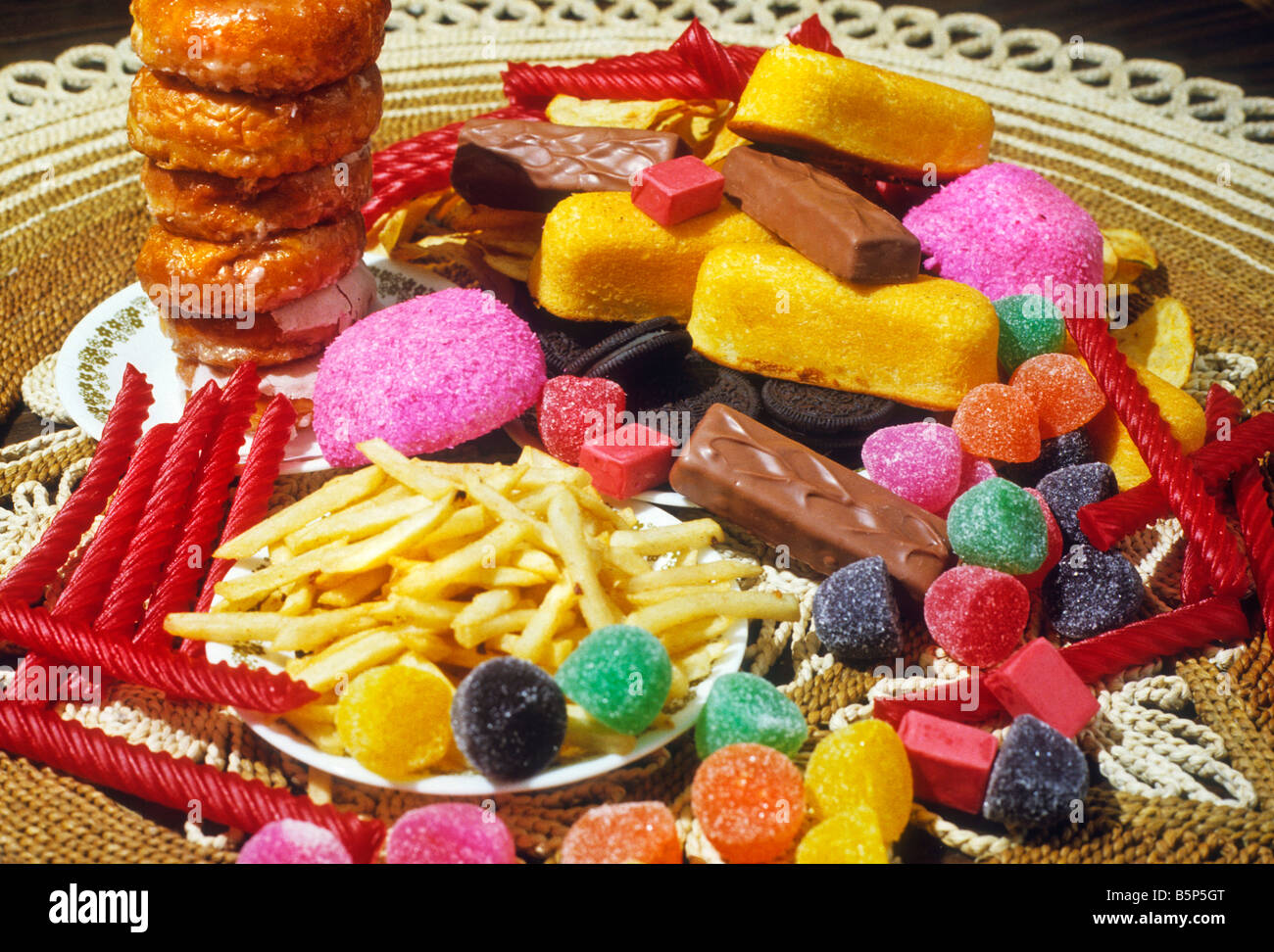 High sugar content foods including donuts, candy, French fries Stock ...