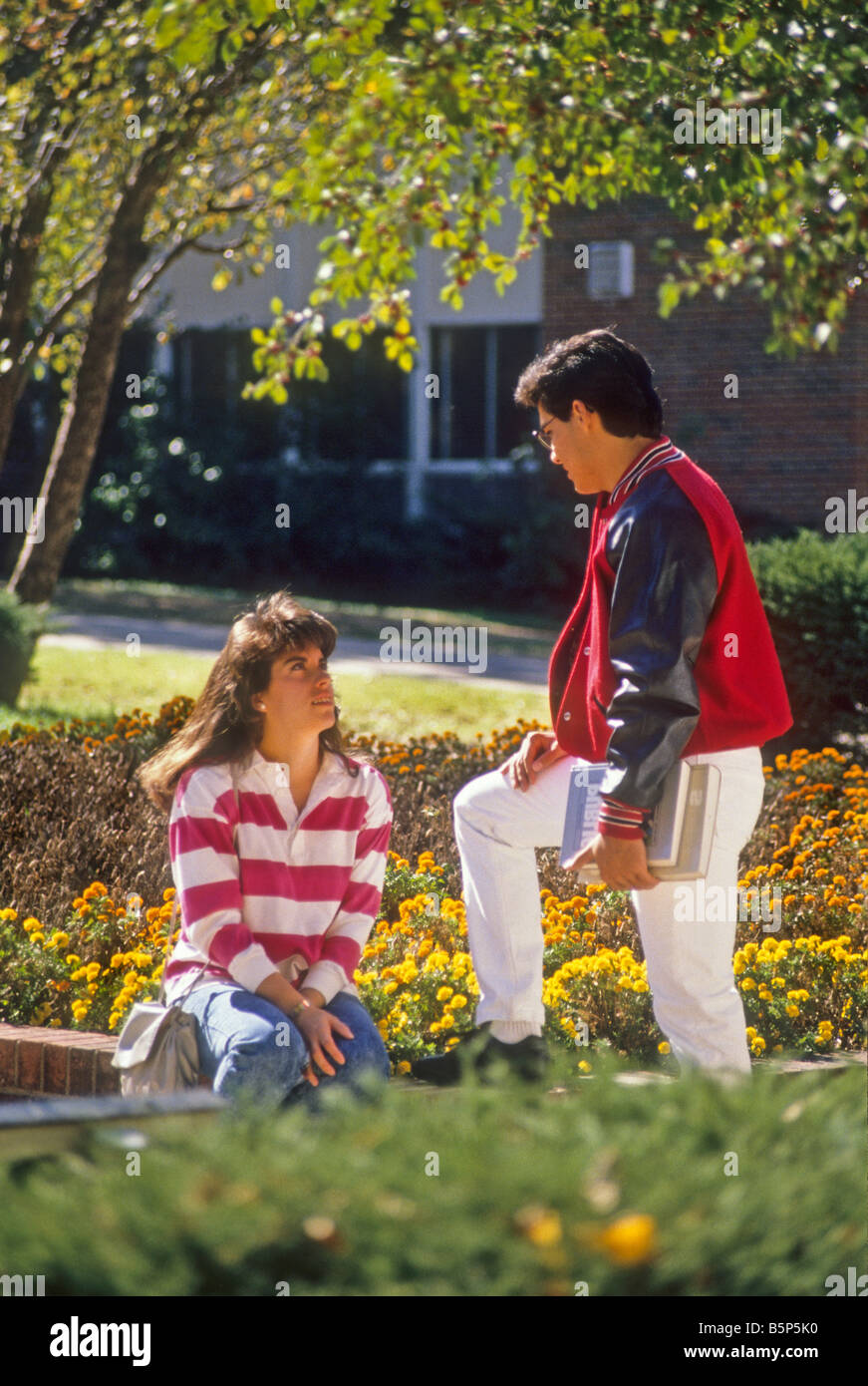 Young Hispanic couple talk on college campus racially mixed married ...
