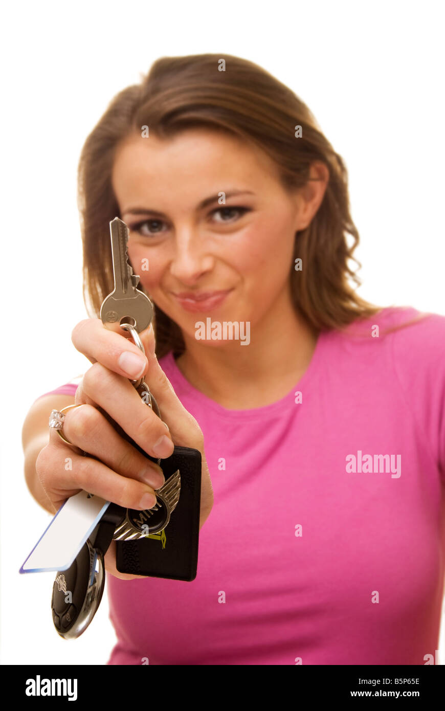 woman holding up a new key on a keyring smiling Stock Photo - Alamy