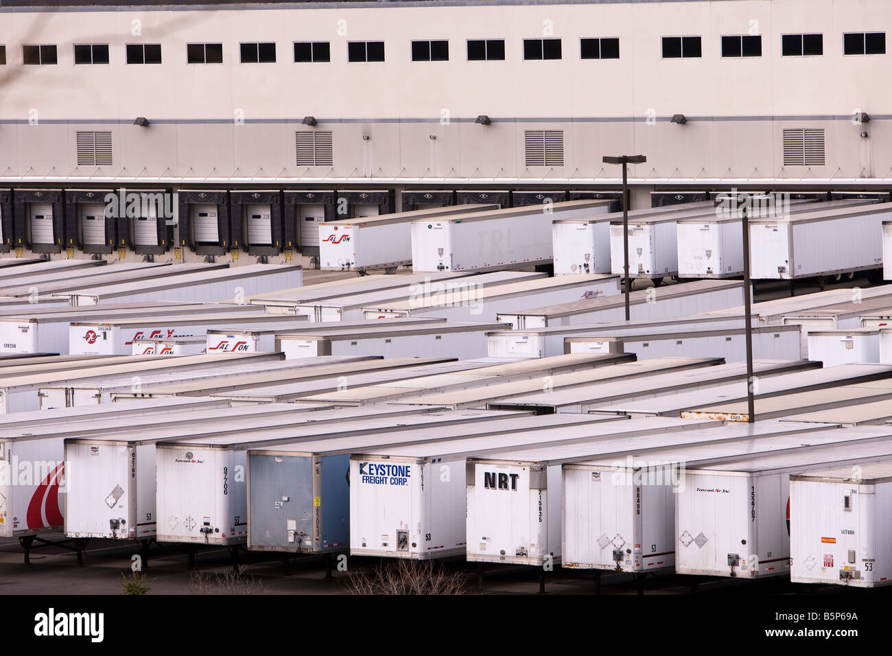 Trailers at a warehouse Stock Photo - Alamy