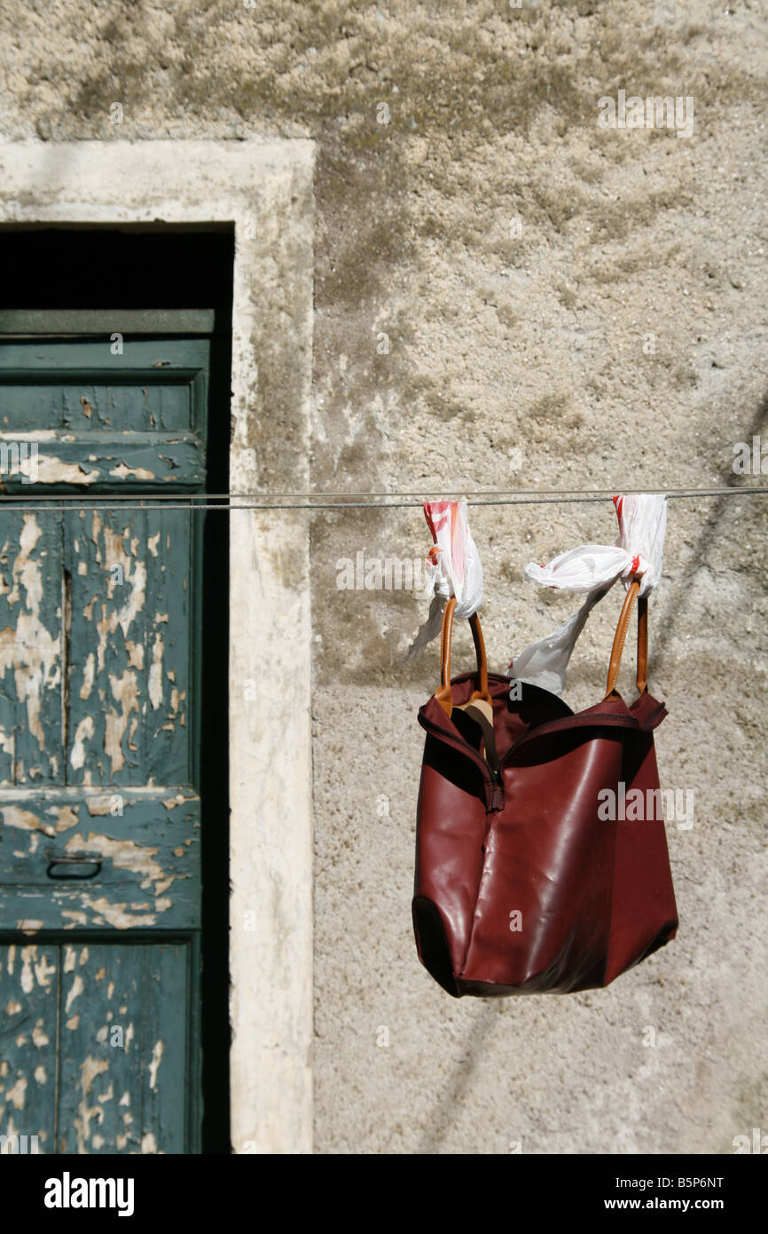 old woman's bag used as a peg container holder on clothes line in italy ...