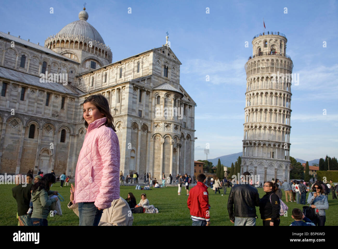 Tourists pose in front of the Leaning Tower of Pisa in the Piazza dei ...