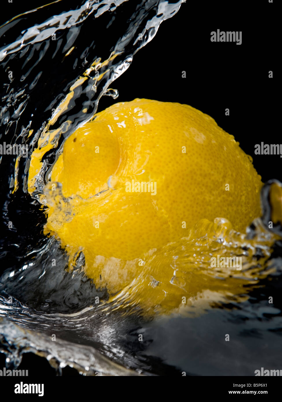 lemon with water on black background Stock Photo - Alamy