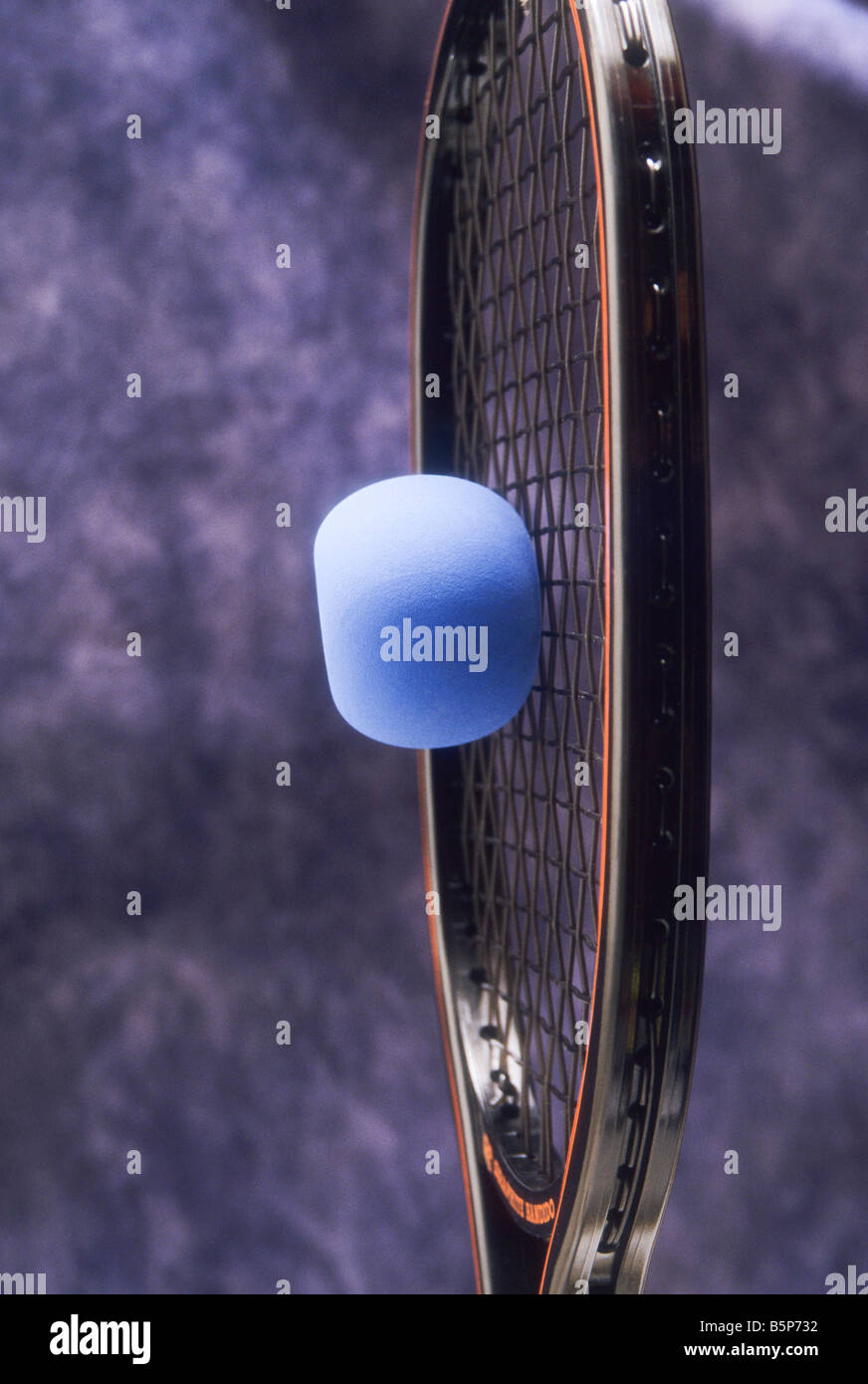Blue rubber ball impacts racquet and distorts shape Stock Photo - Alamy
