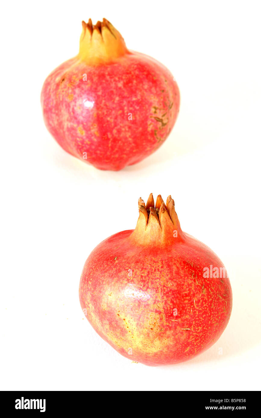 two pomegranate focus on the front isolated on white Stock Photo - Alamy