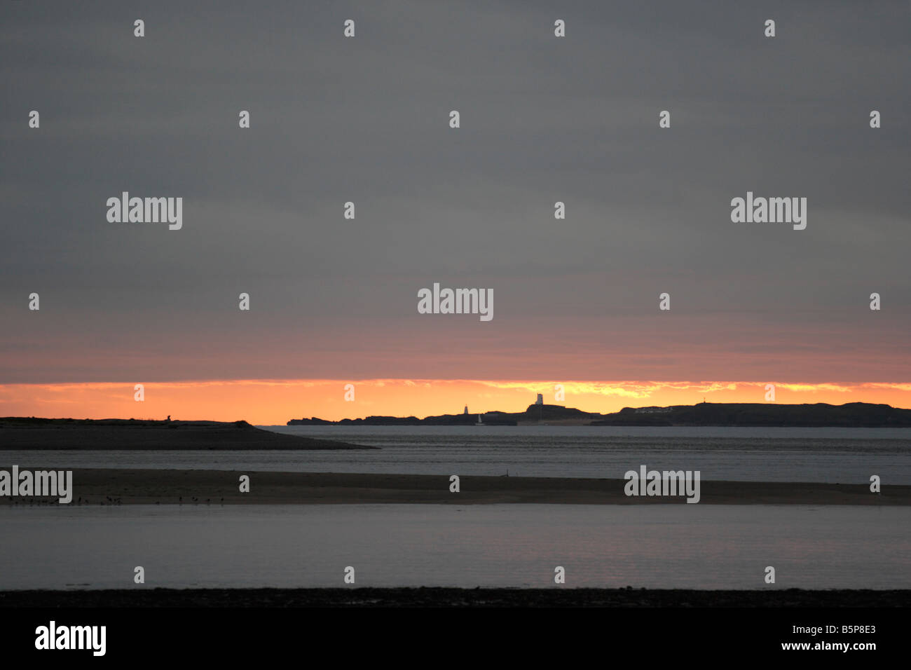 Sunset and rain clouds over Anglesey viewed from the Caernarfon side of ...