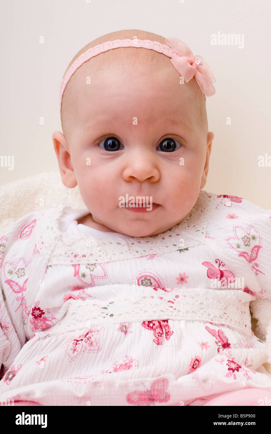 Pretty baby girl looking at the camera Stock Photo - Alamy