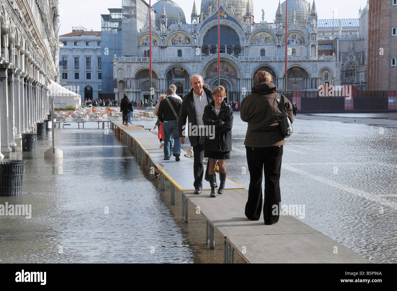 Flooding of St Mark's Square, Venice, during high tide. Tourists ...